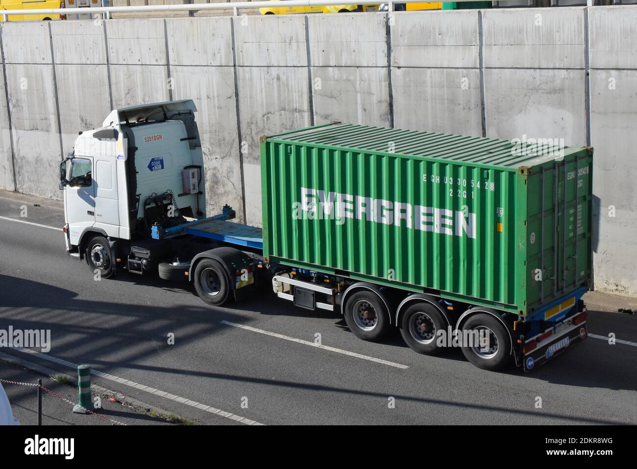 White truck with trailer Evergreen container in a dual carriageway ...