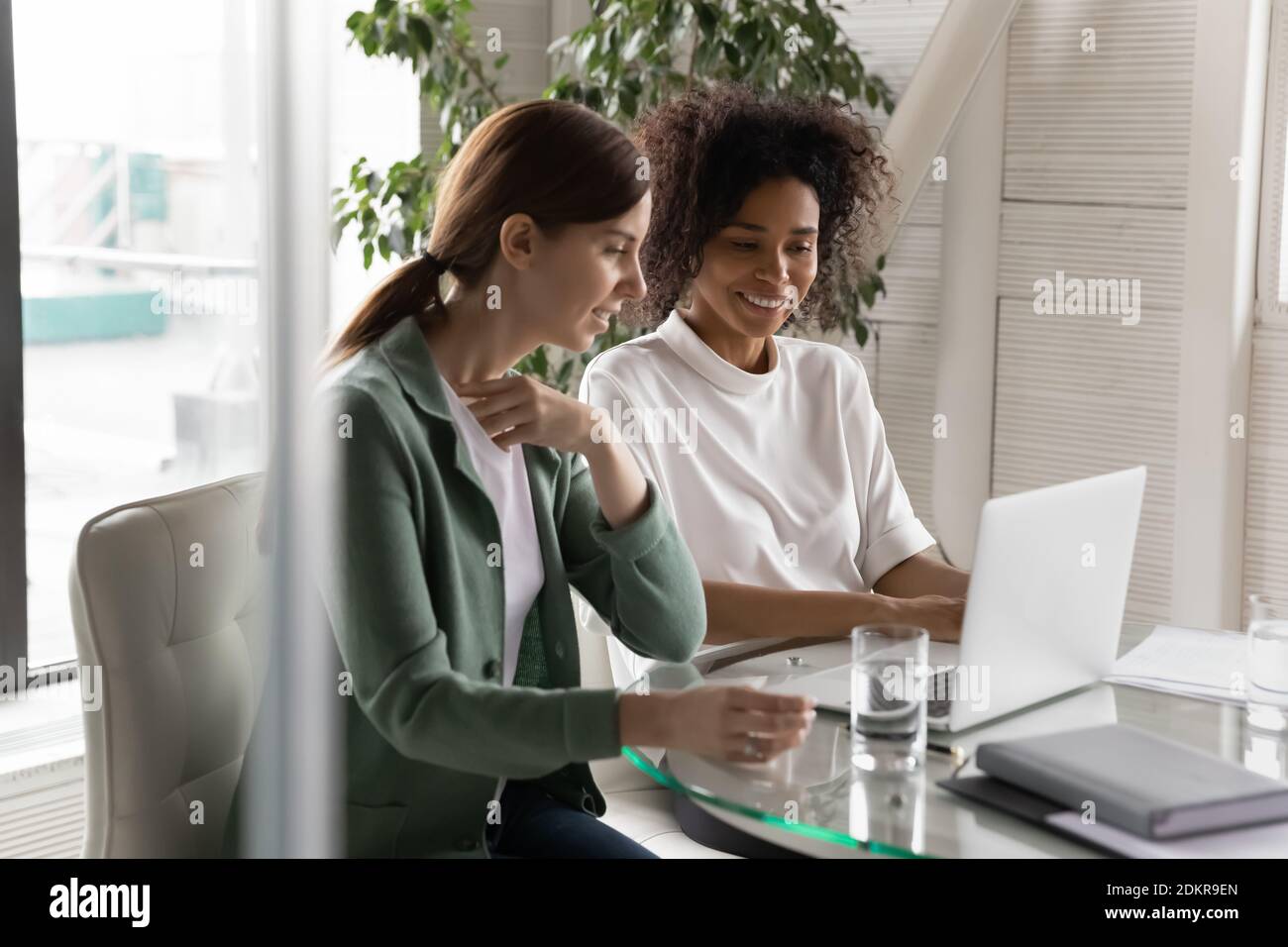 Smiling female employees work hi-res stock photography and images - Alamy