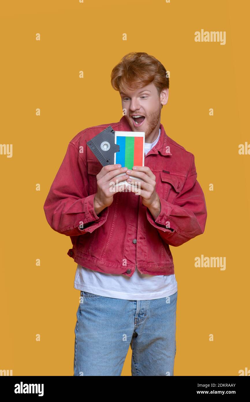 Ginger young man in red jacket with a record Stock Photo - Alamy