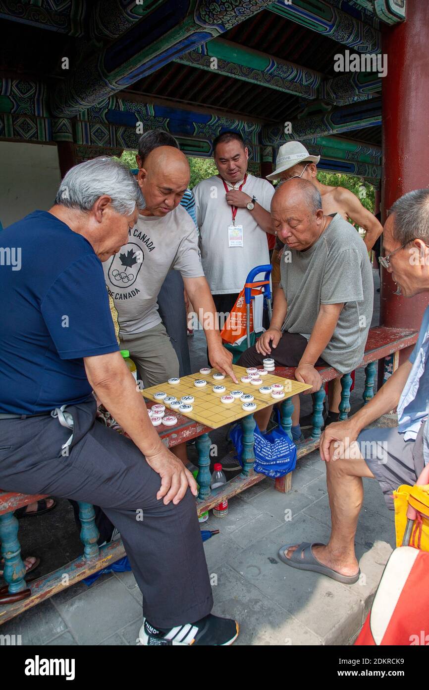 Older men playing traditional Chinese Checkers game in gardens of ...