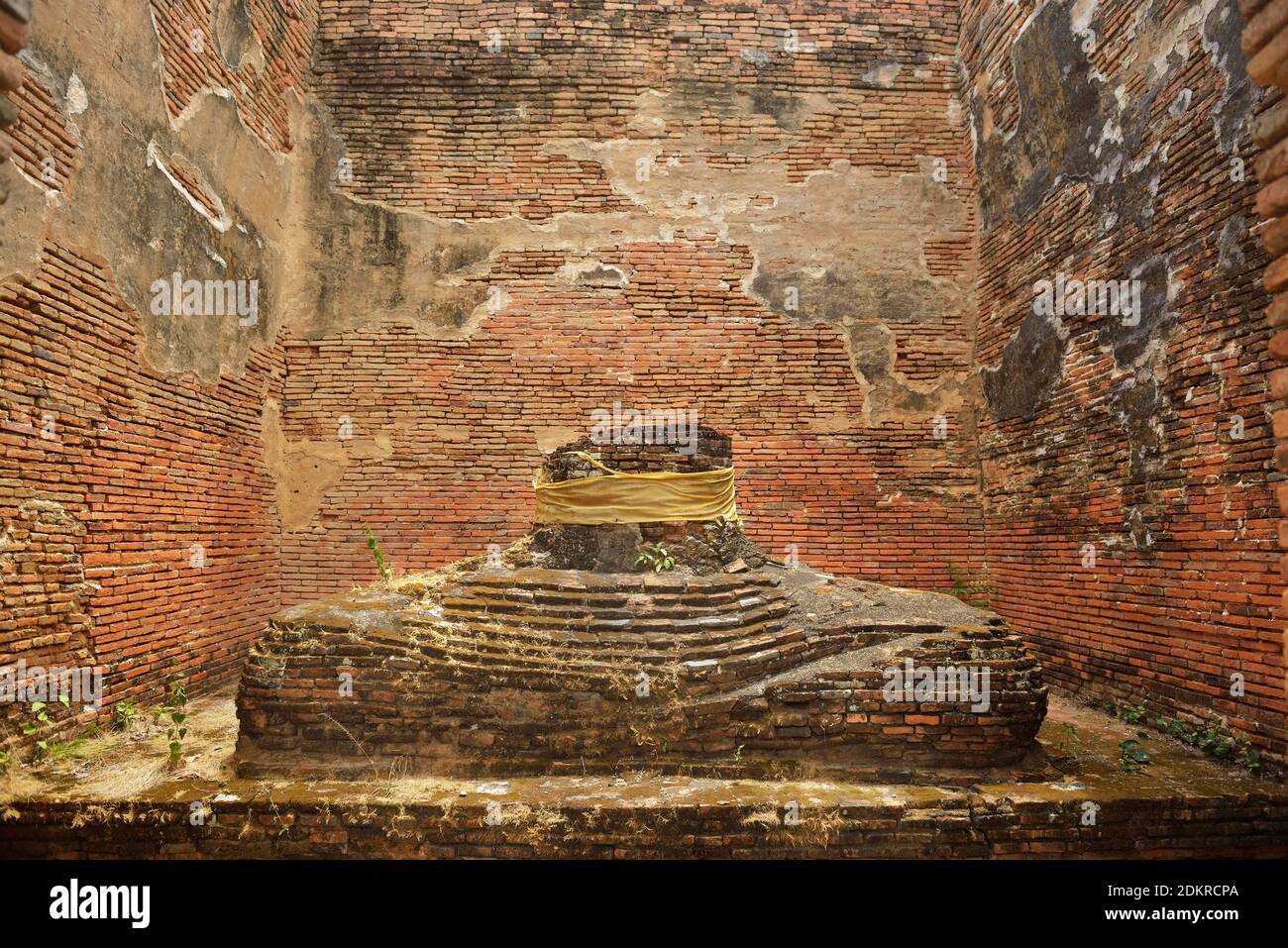 Damaged sculpture in old temple. Only pedestal survived Stock Photo - Alamy