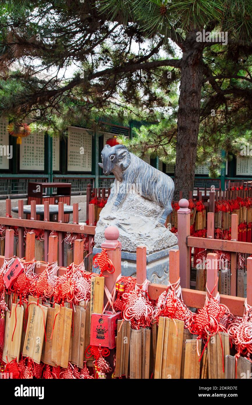Red Chinese prayer sticks with statue for Year of the Goat near Great ...