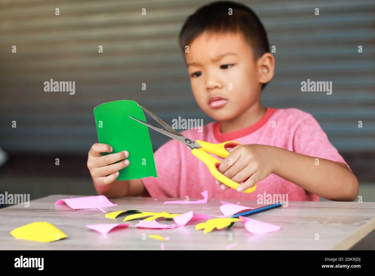 Elementary Boy Cutting Paper Scissors High Resolution Stock Photography ...