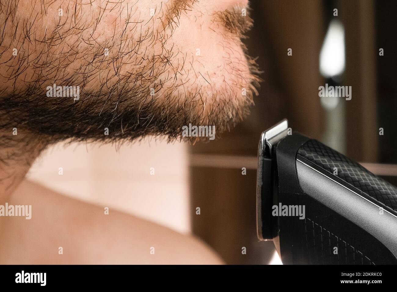 Front view on the man shaving his cheek using electric razor Stock ...