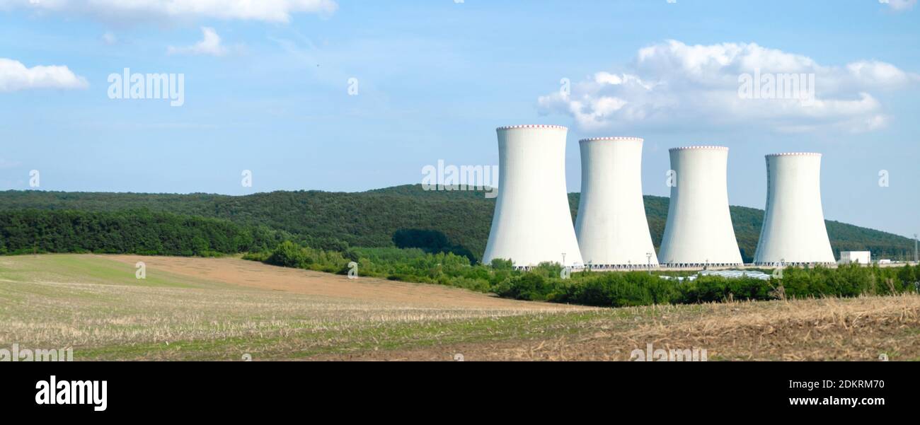 White chimneys of nuclear power plant. Sustainable energy. Banner with ...