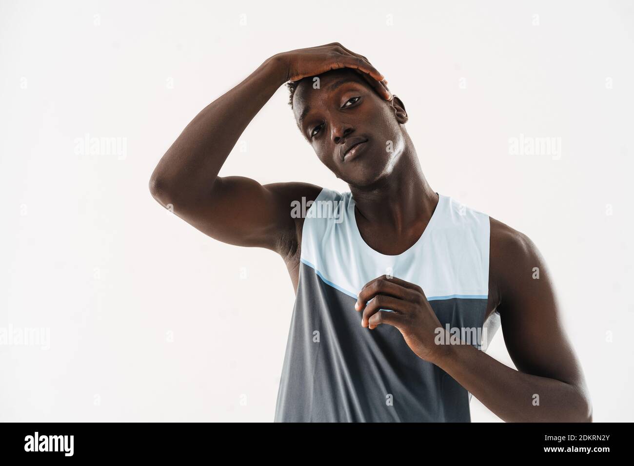 Young african american sportsman stretching his neck while working out ...