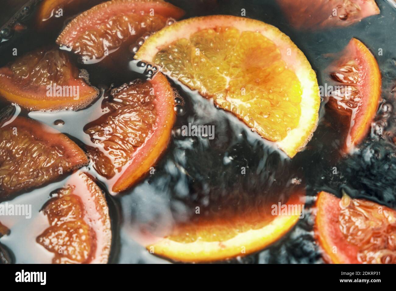 Making of mulled wine or punch with slices of orange, anise slice ...