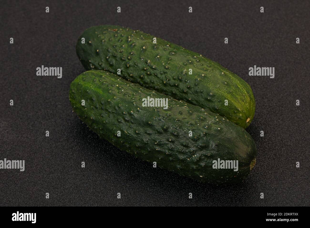 Green fresh two cucumbers over background Stock Photo - Alamy