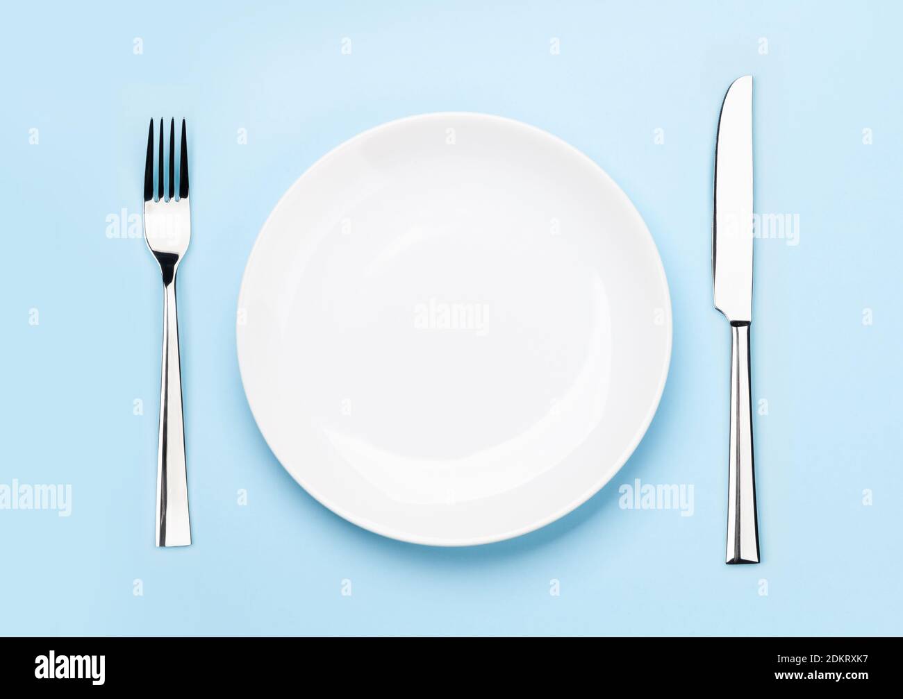 Empty plate, fork and knife. Top view flat lay with copy space Stock Photo - Alamy