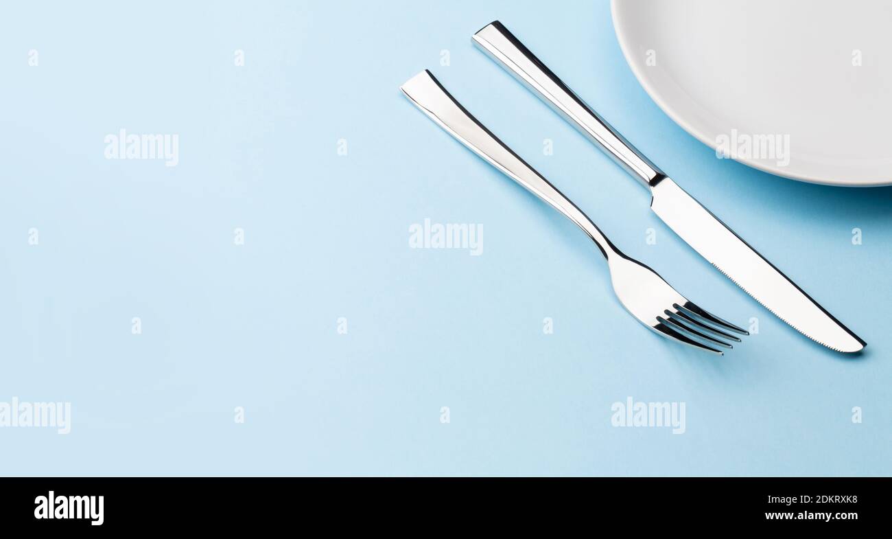 Empty plate, fork and knife. Top view with copy space Stock Photo - Alamy