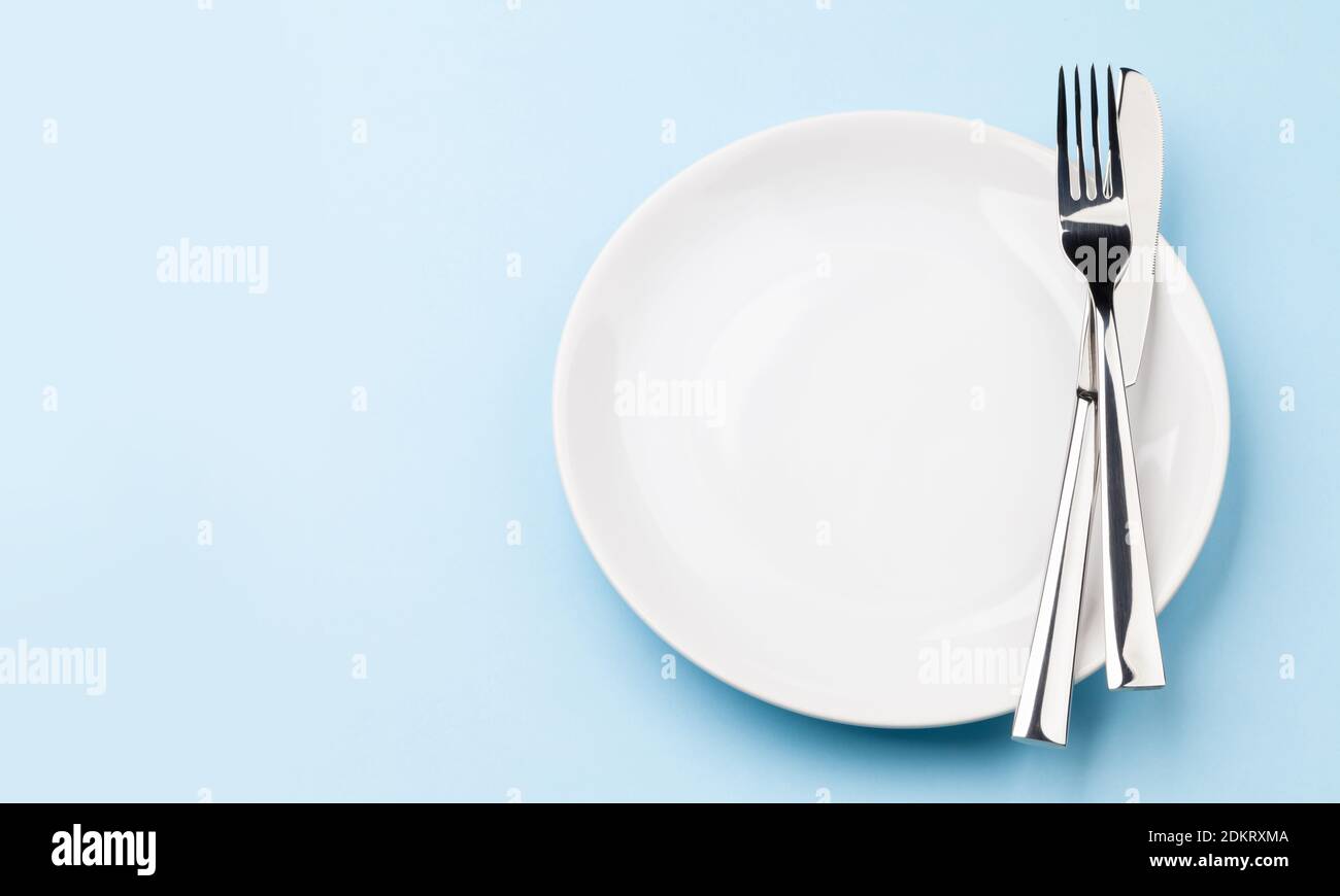 Empty plate, fork and knife. Top view flat lay with copy space Stock Photo - Alamy