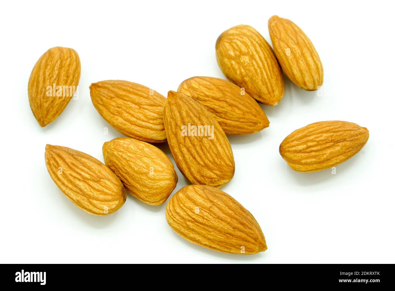 Almond-golden almonds isolated on a white background Stock Photo - Alamy