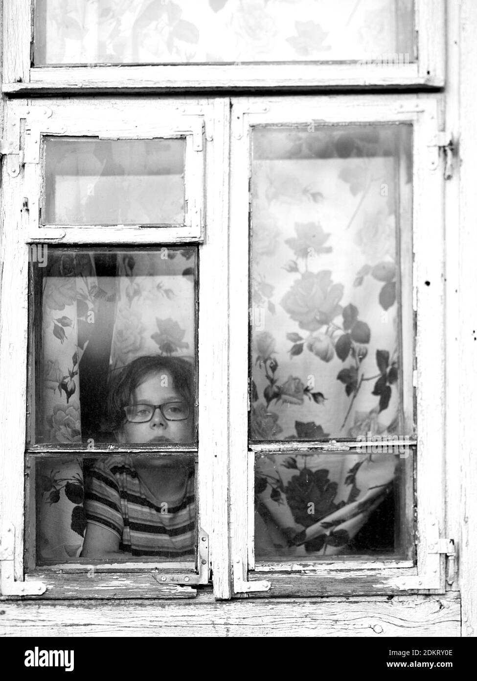 Boy looking in window Black and White Stock Photos & Images - Alamy