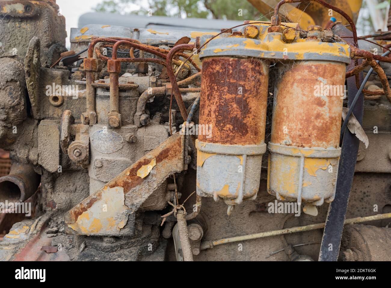 A close up of an old and rusted diesel engine with flecks of yellow ...