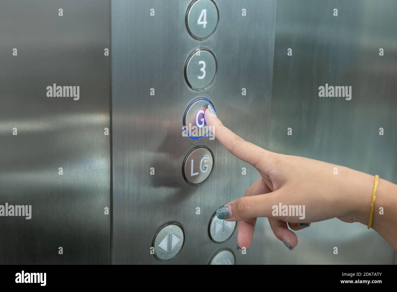 Elevator buttons woman hi-res stock photography and images - Alamy