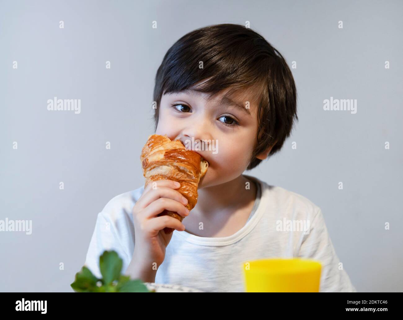 Boy eating croissant hi-res stock photography and images - Alamy