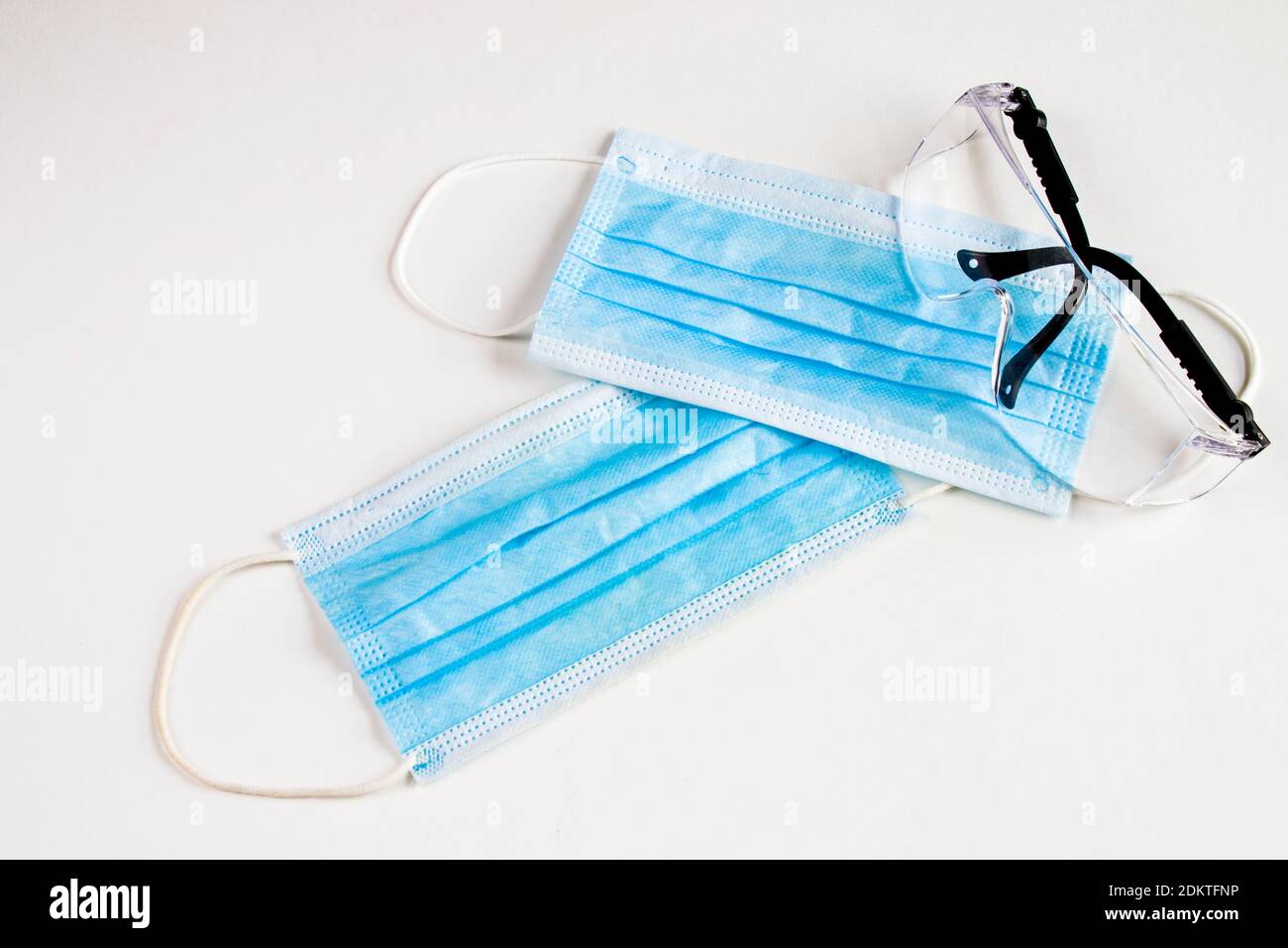 Face masks and safety glasses on the white background, sterile ...