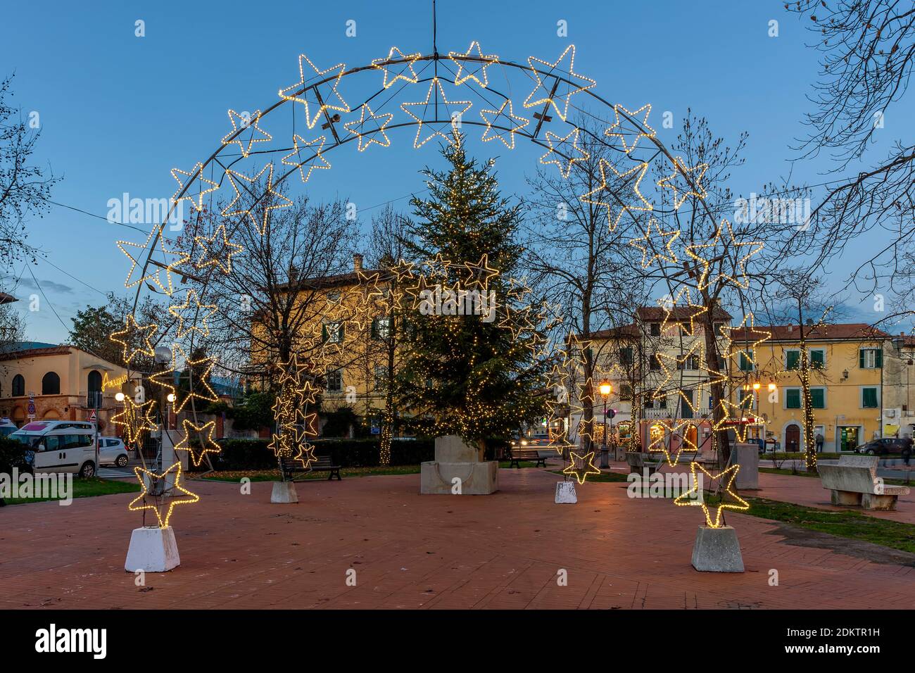 Star-shaped fairy lights arches and decorated Christmas tree in Piazza ...