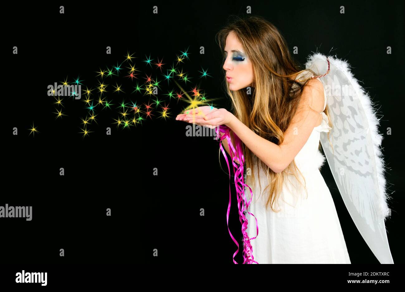 Fairy scatters fairy dust on black background Stock Photo - Alamy