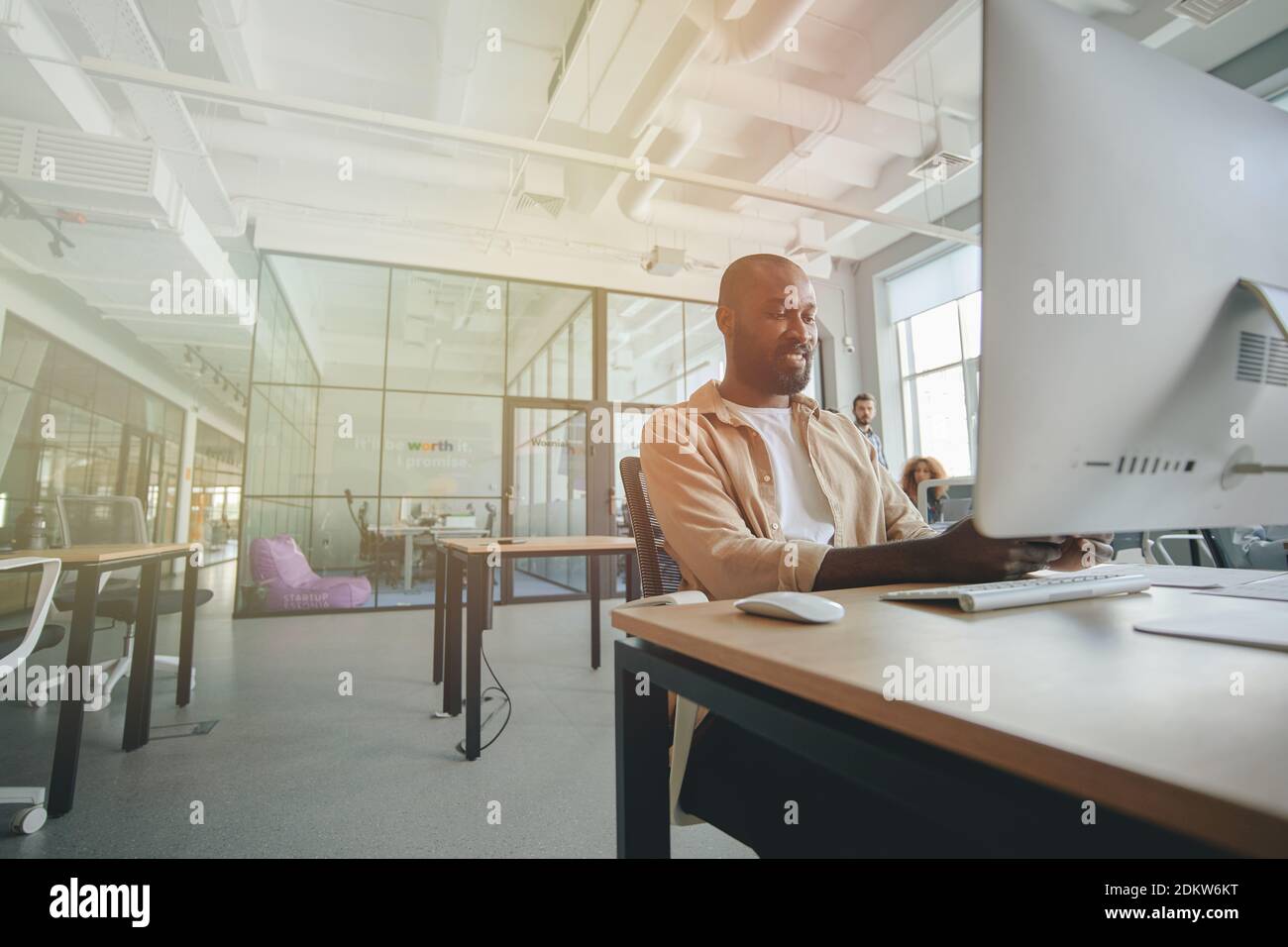 Ambitious African American gentleman working at modern office Stock ...
