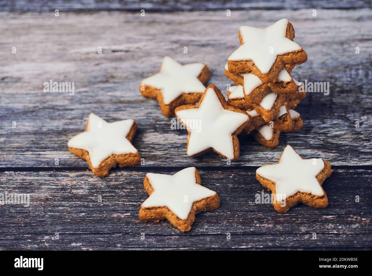 a lot of cinnamon stars on brown dark wooden background with copy space ...