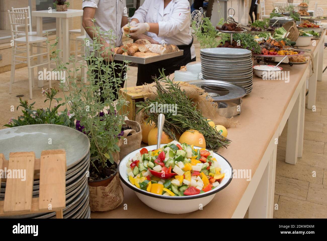 An assortment of foods in bowls on a buffet table during a daytime ...