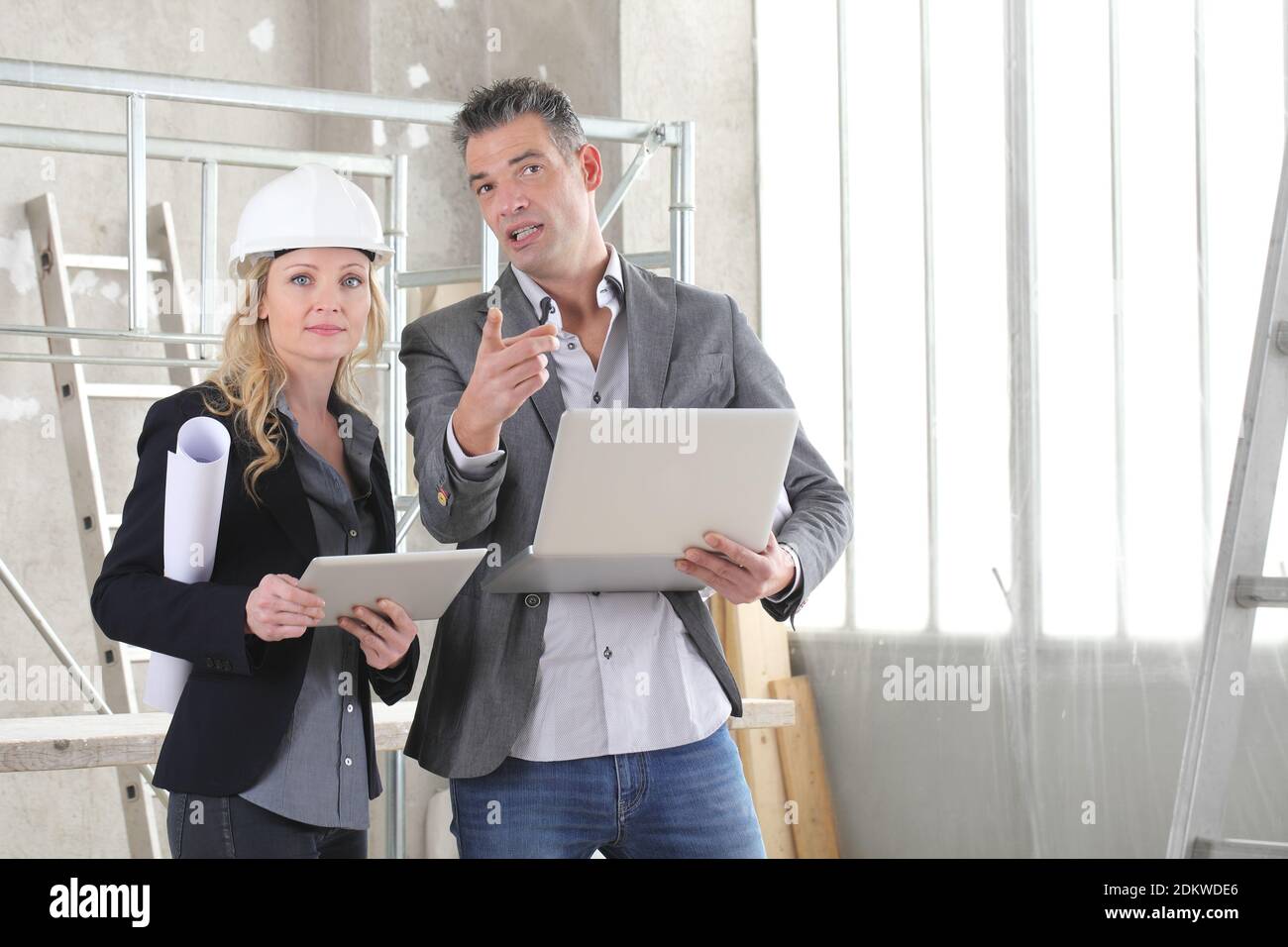 man and woman architects or engineers with computer work together in ...
