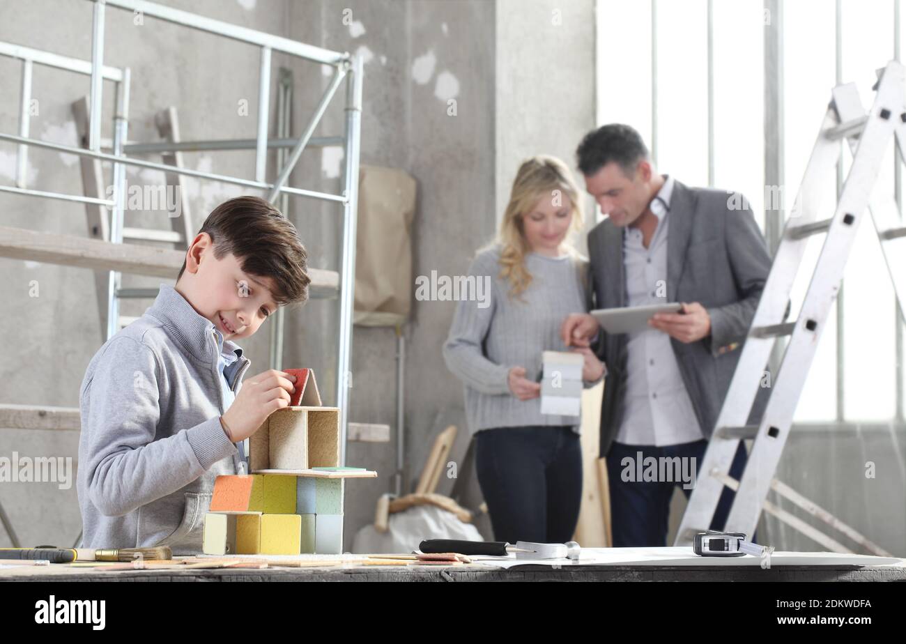 Happy children playing building a house with construction models. His ...