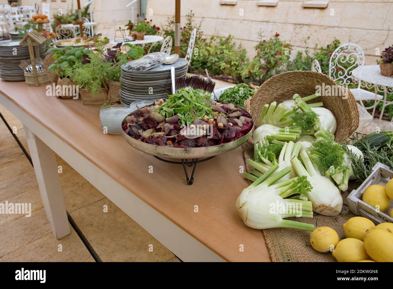 An assortment of foods in bowls on a buffet table during a evening ...