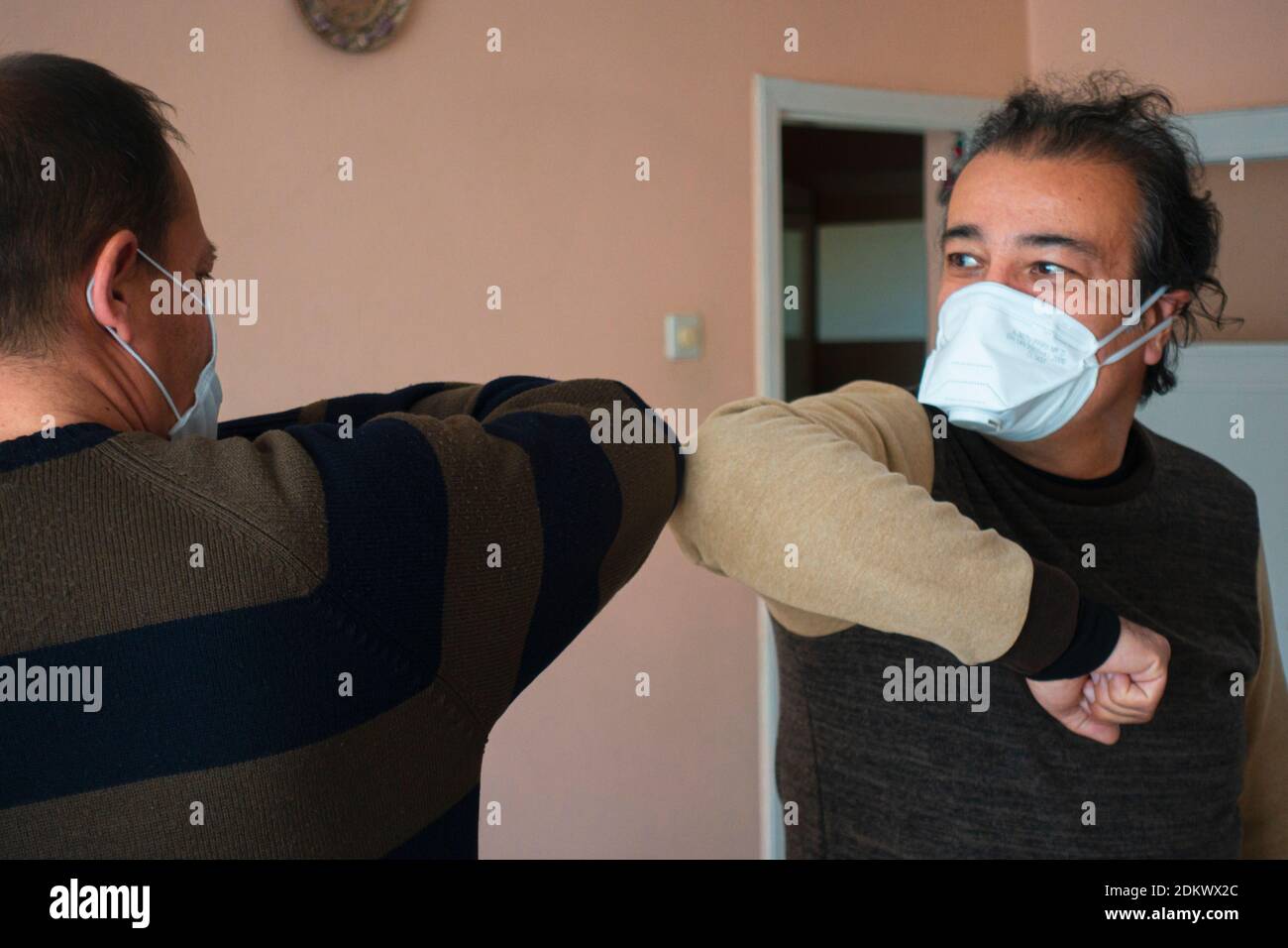 Elbow touching greeting hi-res stock photography and images - Alamy