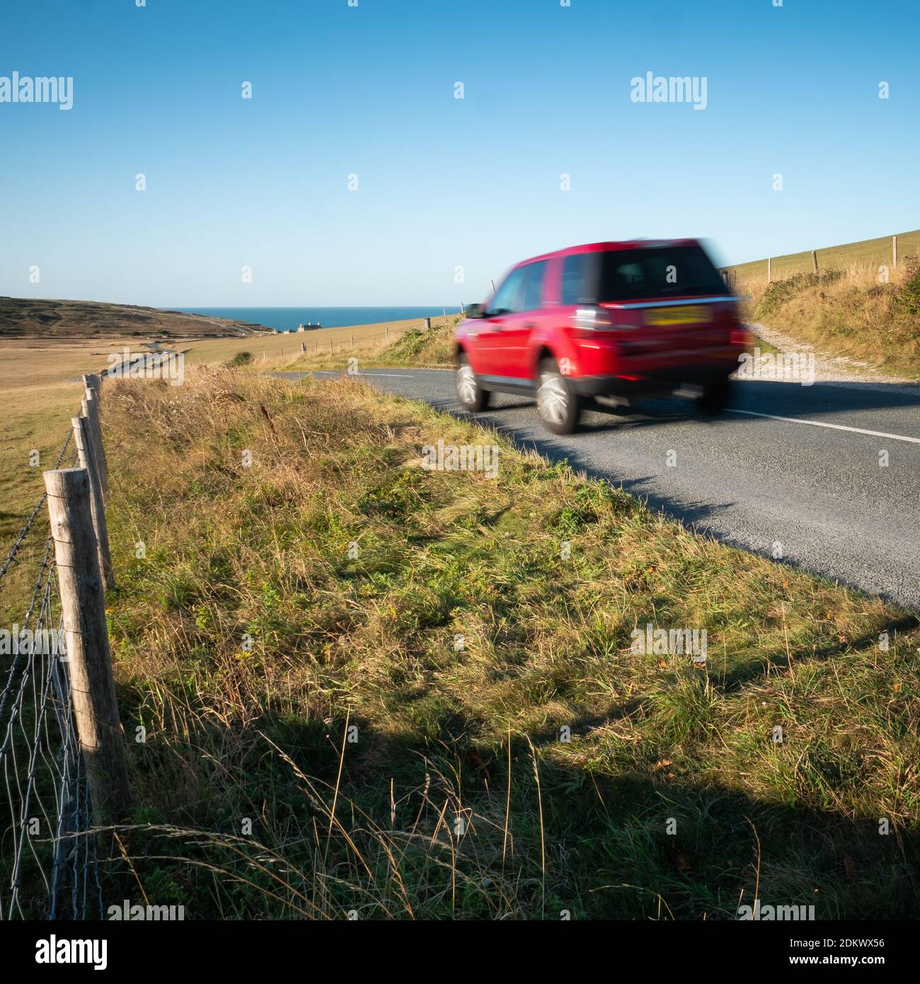 English Road Trip. A car travelling a winding road on the South Downs ...