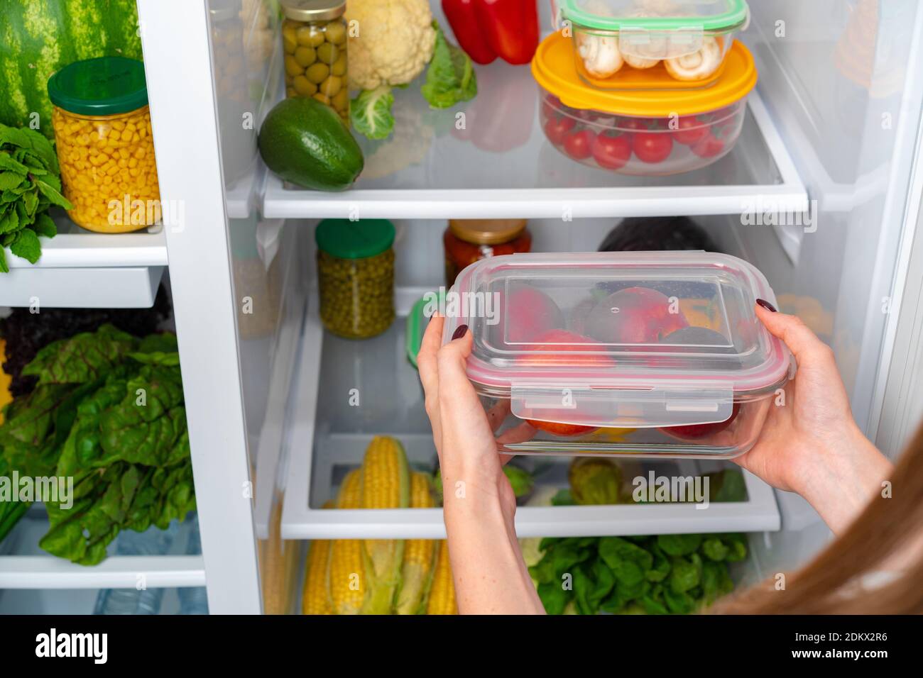 Female hands taking storage box with food from a fridge Stock Photo - Alamy