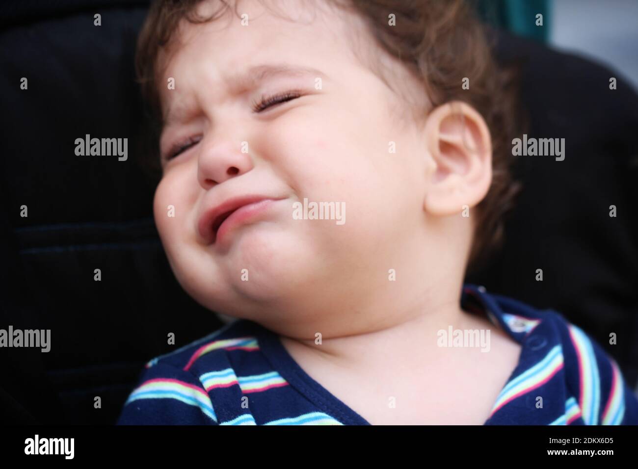 Crying Baby Boy Sitting On Chair High Resolution Stock Photography and ...