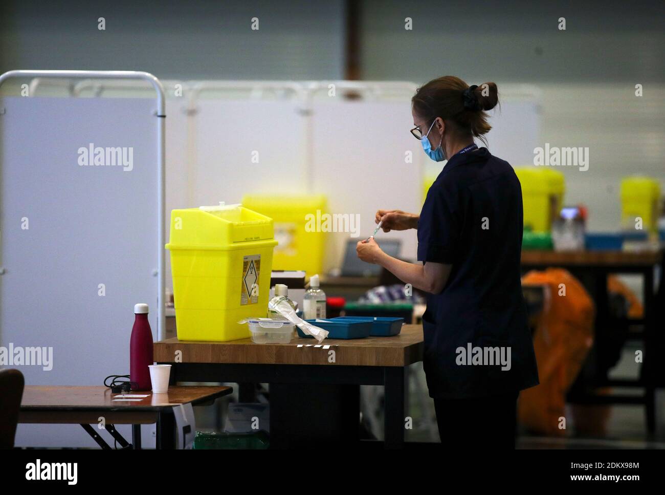 Nurse Justine Braid prepares the first of two injections with a dose of ...