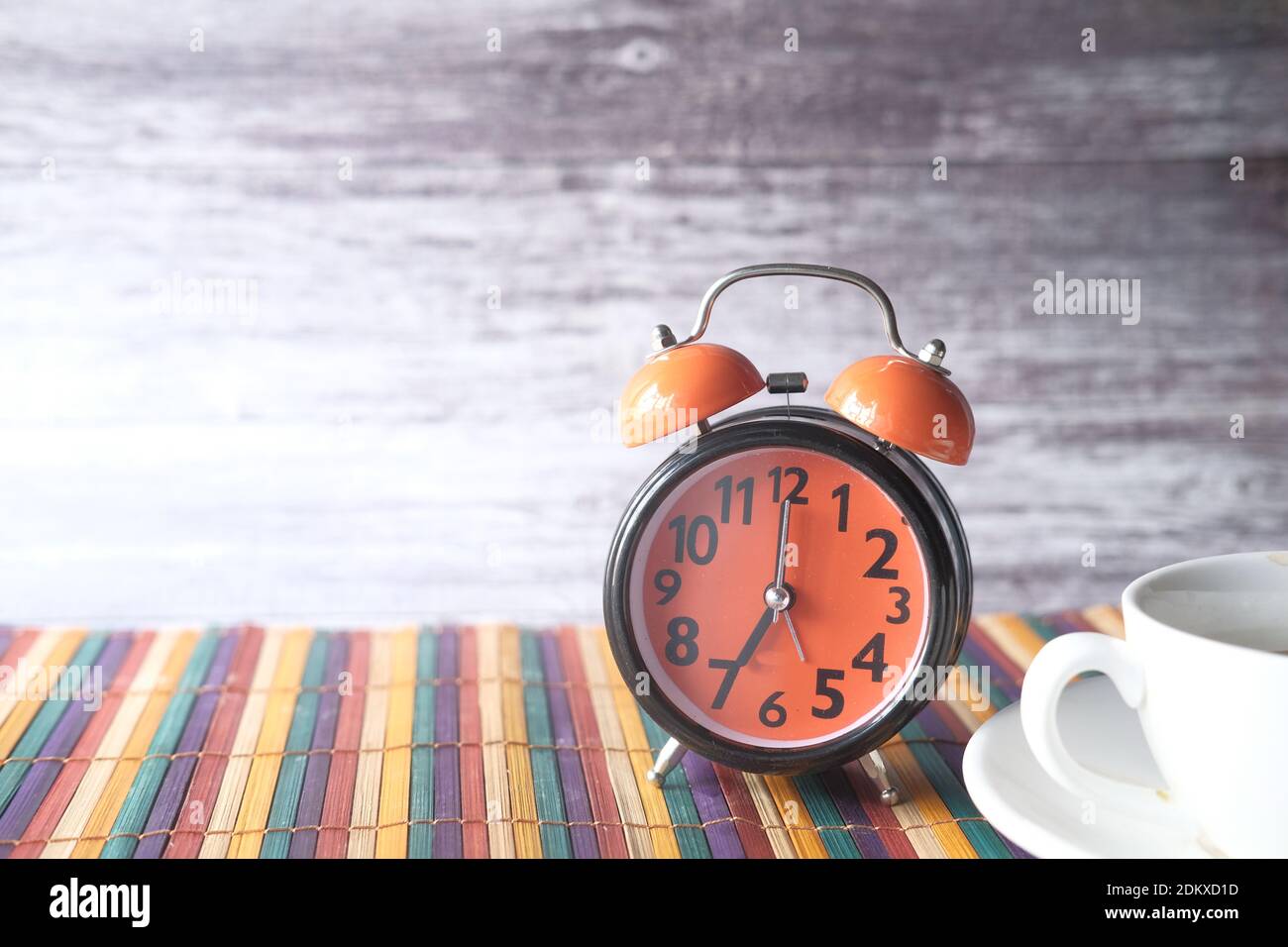 tea cup and old alarm clock on table Stock Photo - Alamy