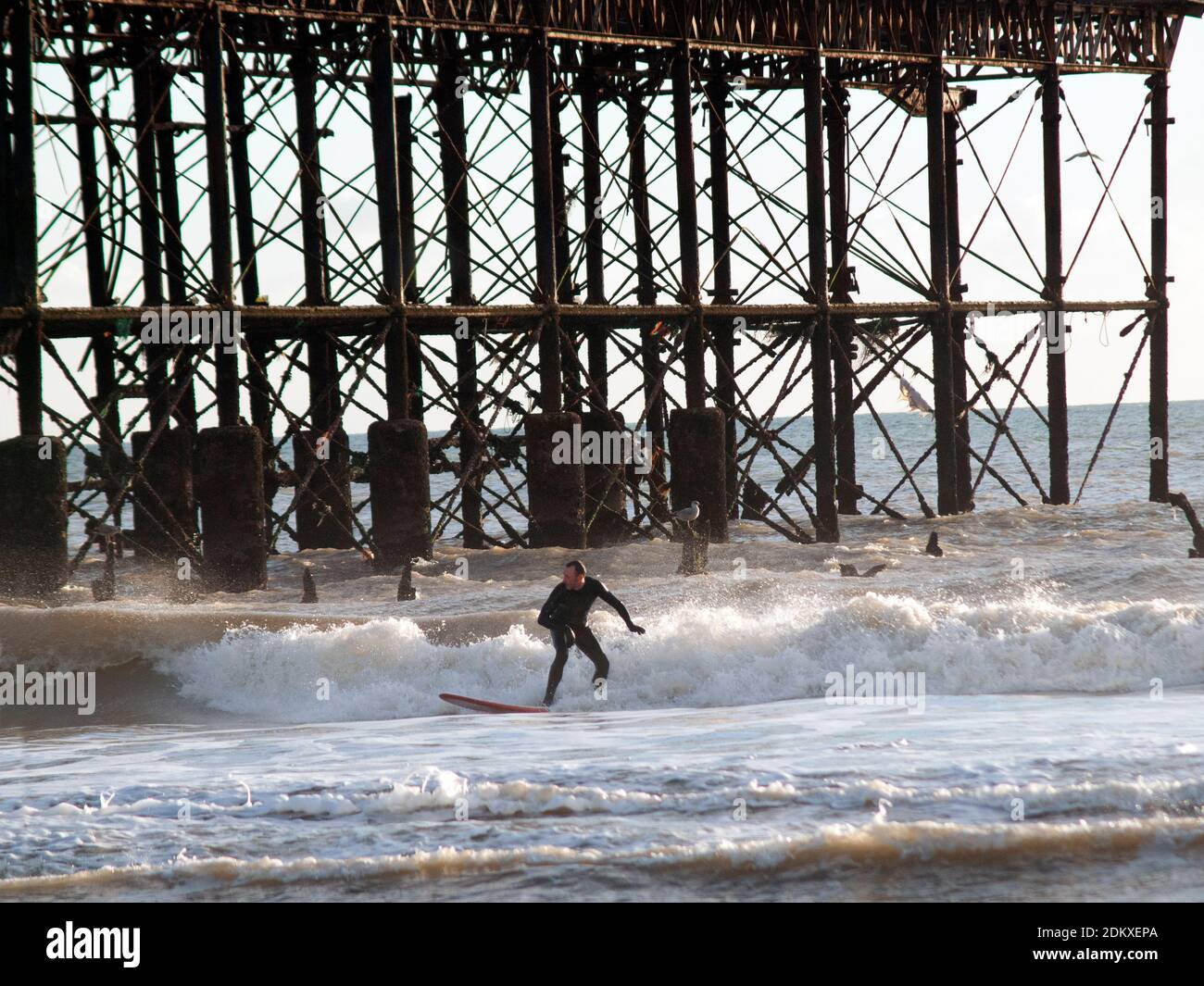 Surfing close to the old West Pier in Brighton Stock Photo - Alamy