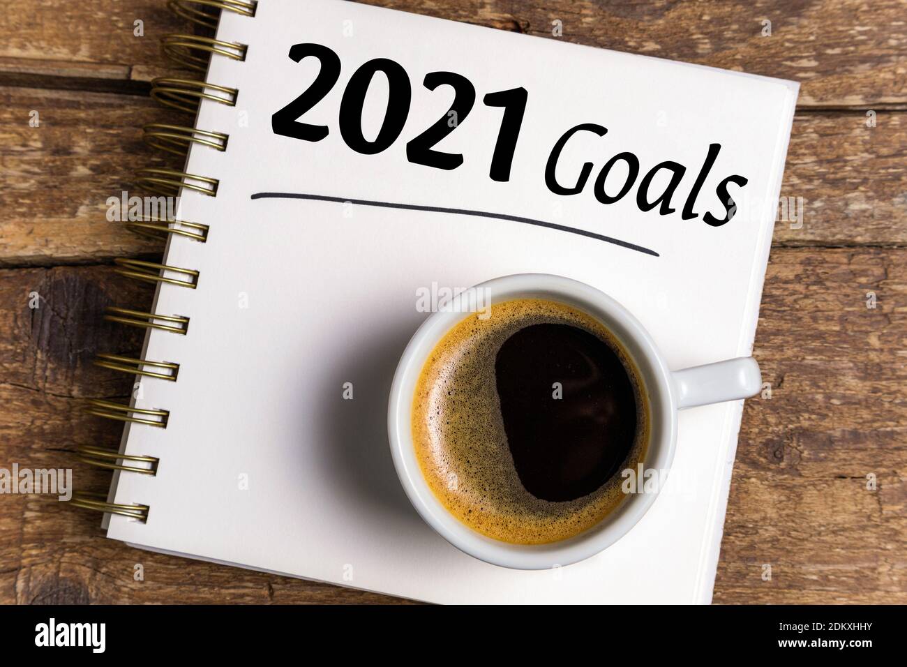 New year goals 2021 on desk. 2021 goals list with notebook, coffee cup ...