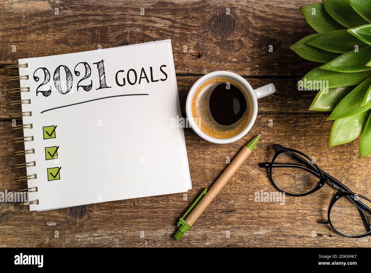 New year goals 2021 on desk. 2021 goals list with notebook, coffee cup ...