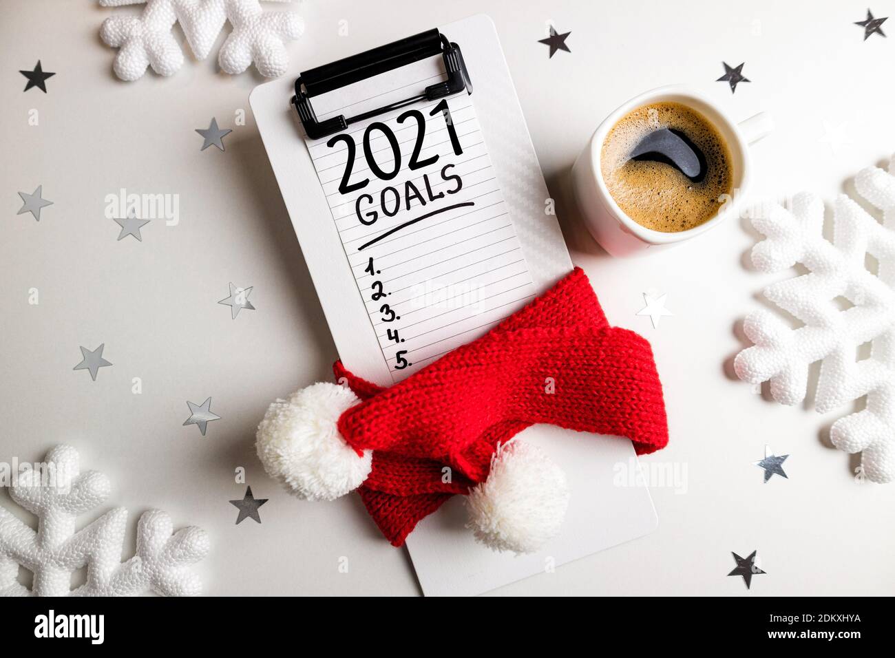 New year goals 2021 on desk. 2021 goals list with notebook, cup of ...
