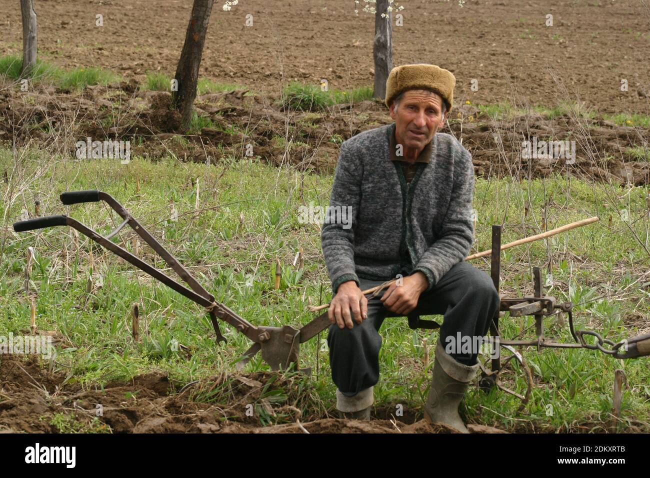 Vrancea County, Romania. Man resting after plowing his field with a ...
