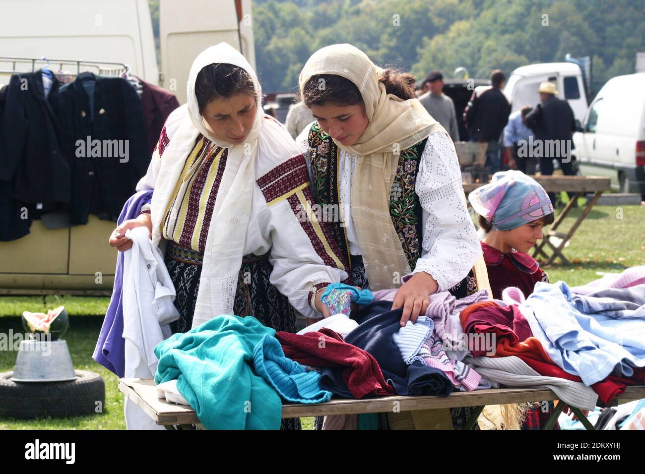 Shoppers at a country fair in Vrancea County, Romania. Women wearing ...