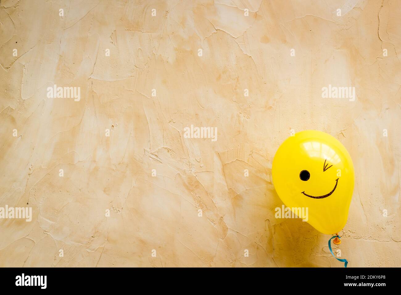 Happiness emotion face on balloon - joy mood background. Top view, copy ...