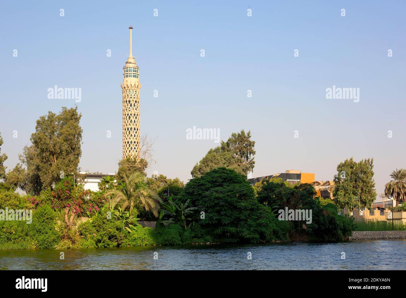 Horizontal shot of Cairo tower with green trees and river Nile ...