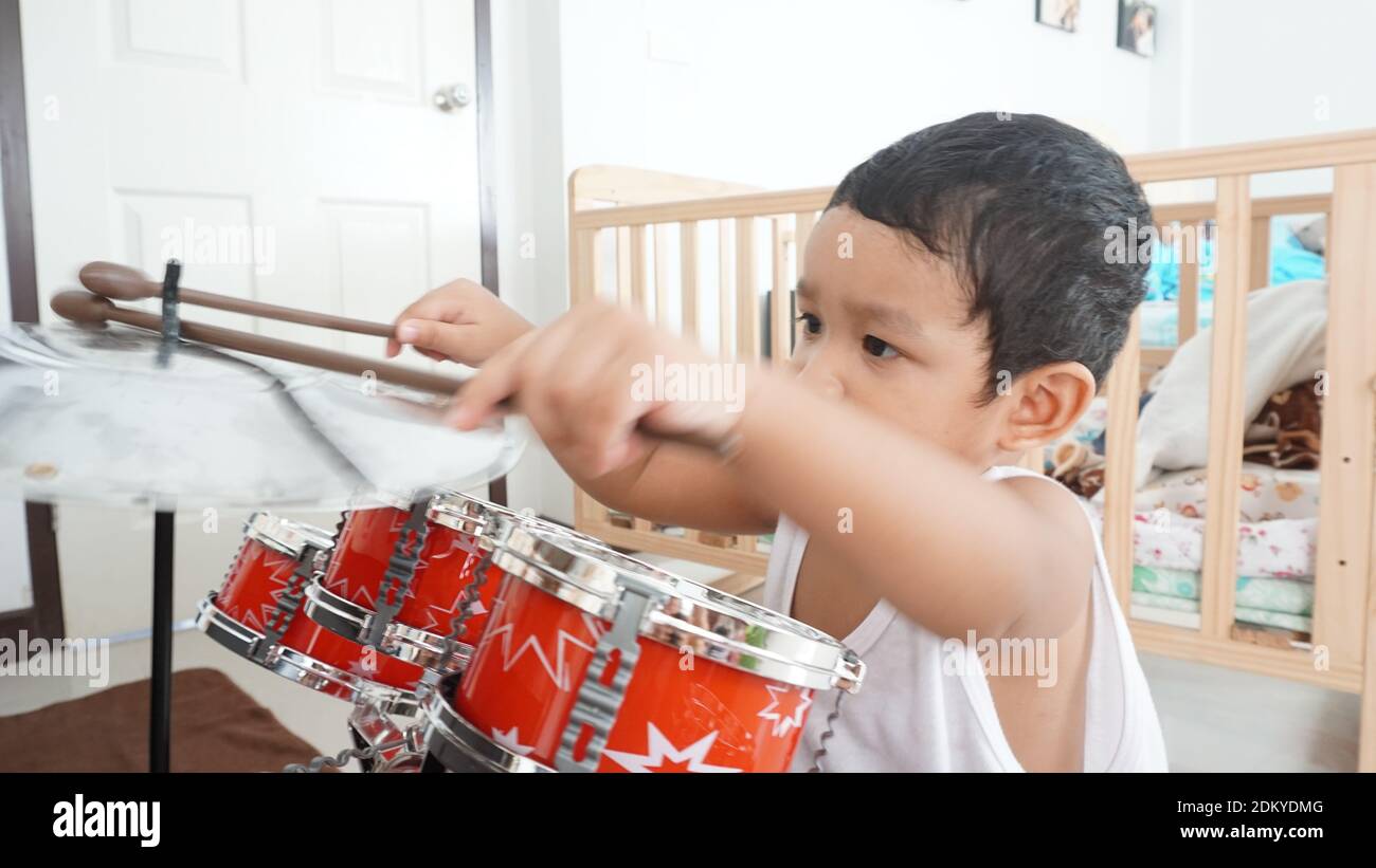 Cute Baby Boy Playing Drum Kit At Home Stock Photo - Alamy