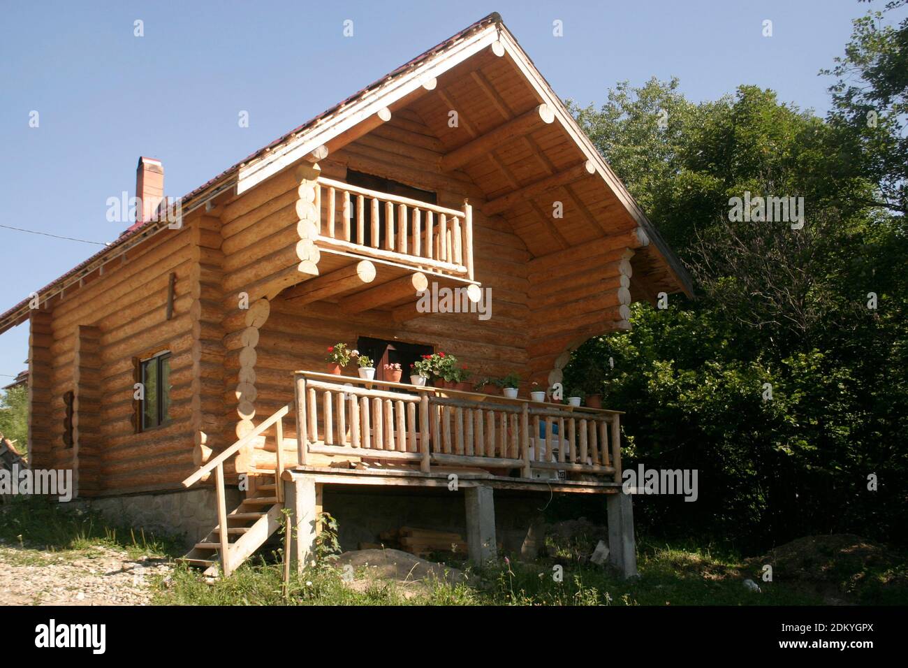 Large stacked log home in Romania Stock Photo - Alamy
