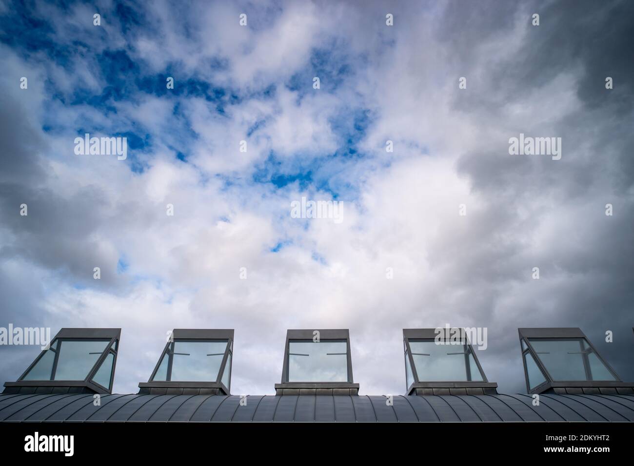 roof windows on a modern building with cloudy sky Stock Photo - Alamy
