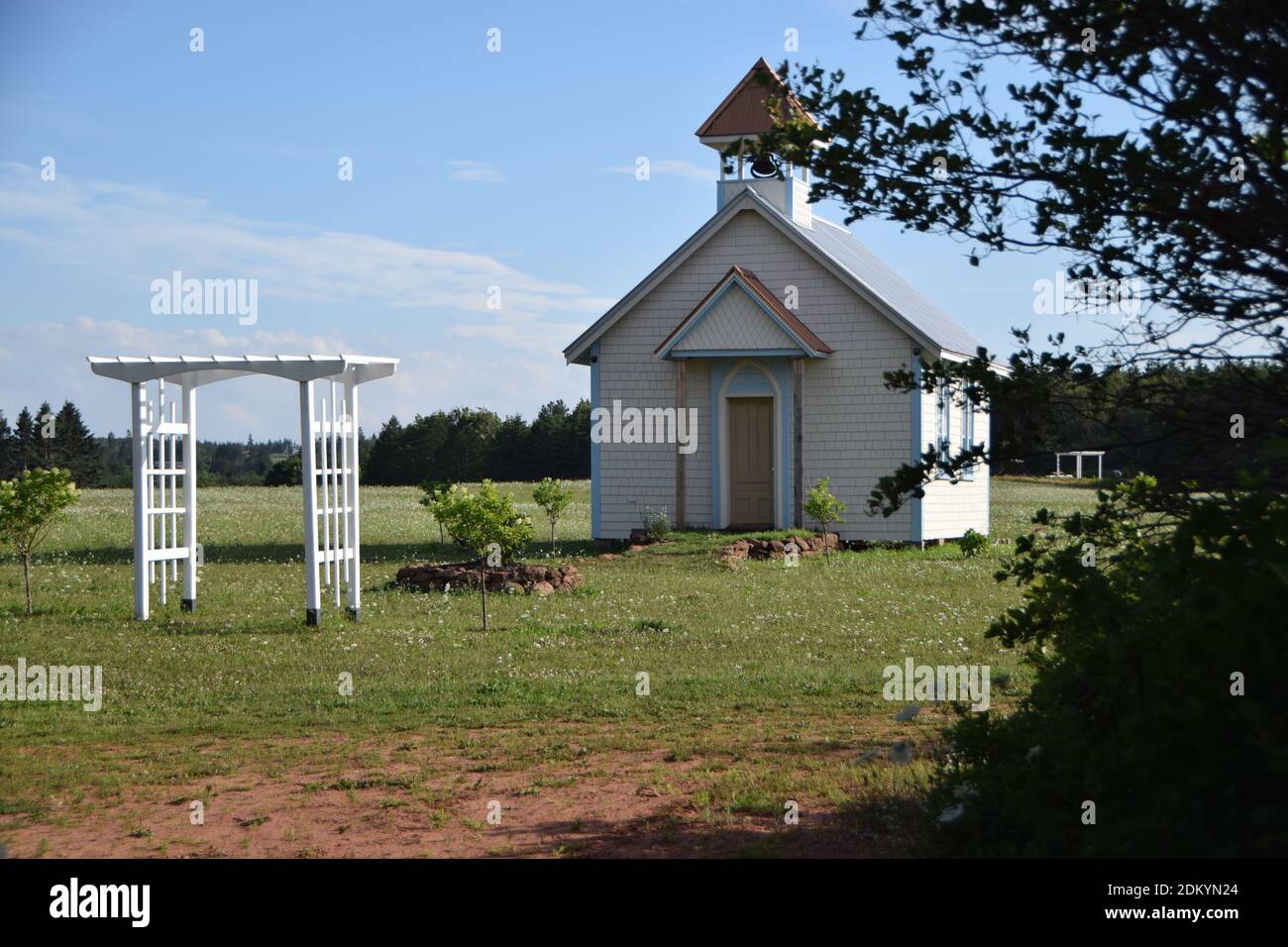 Small white country church in a field with a wooden arbor Stock Photo ...