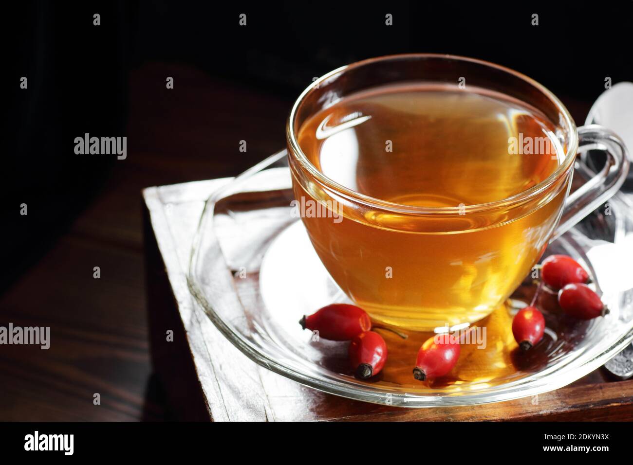 Dog rose herbal tea in a glass cup with hips red berry, vitamin ...