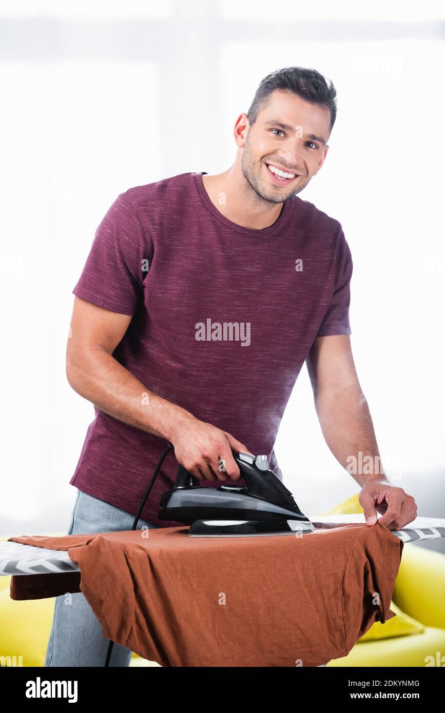 Man ironing clothes hi-res stock photography and images - Alamy