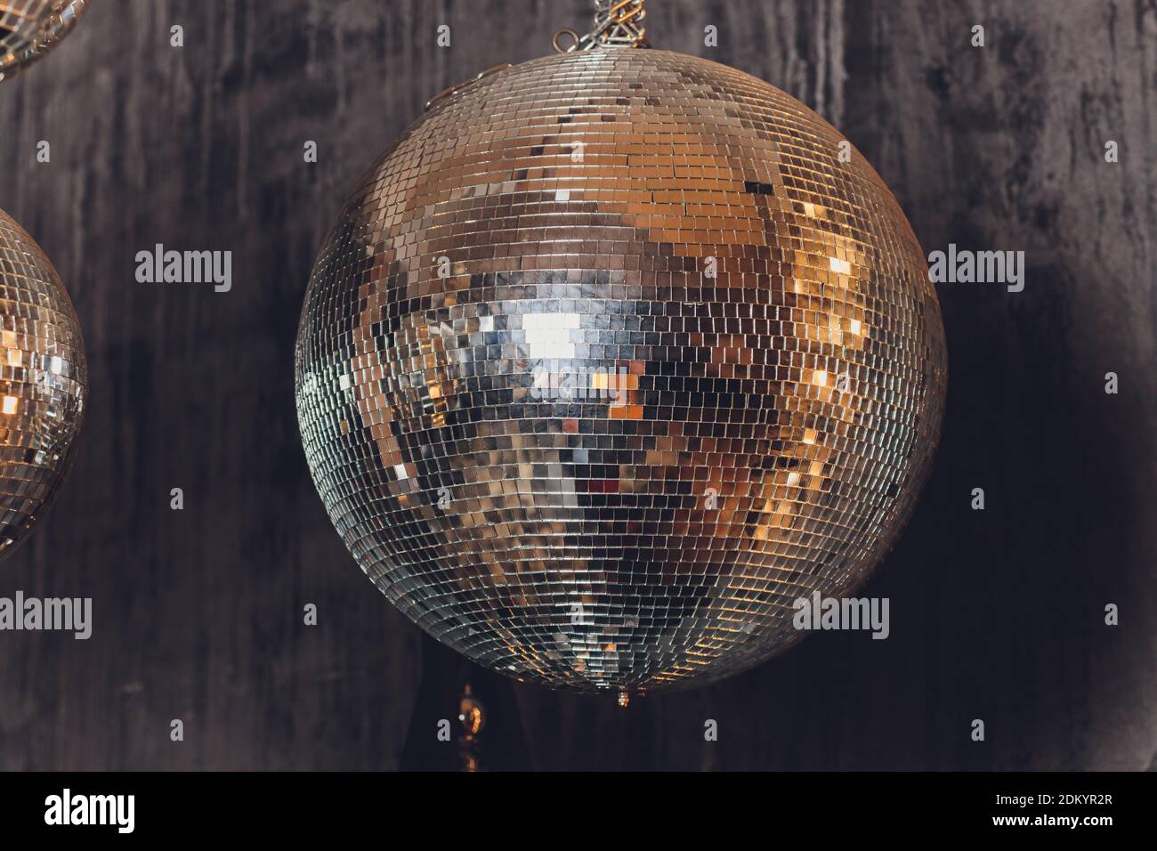 Sparkly disco ball hanging in an empty grungy room Stock Photo - Alamy